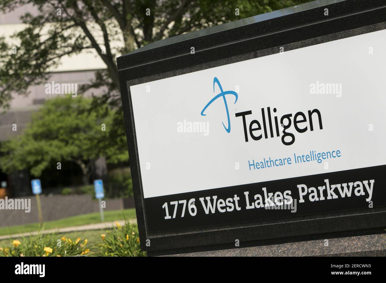 A logo sign outside of the headquarters of Telligen, Inc., in West Des ...
