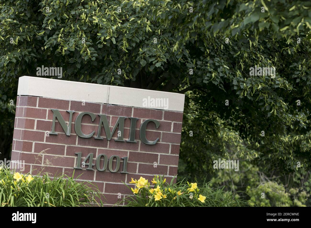 A logo sign outside of the headquarters of the NCMIC Group, Inc., in ...