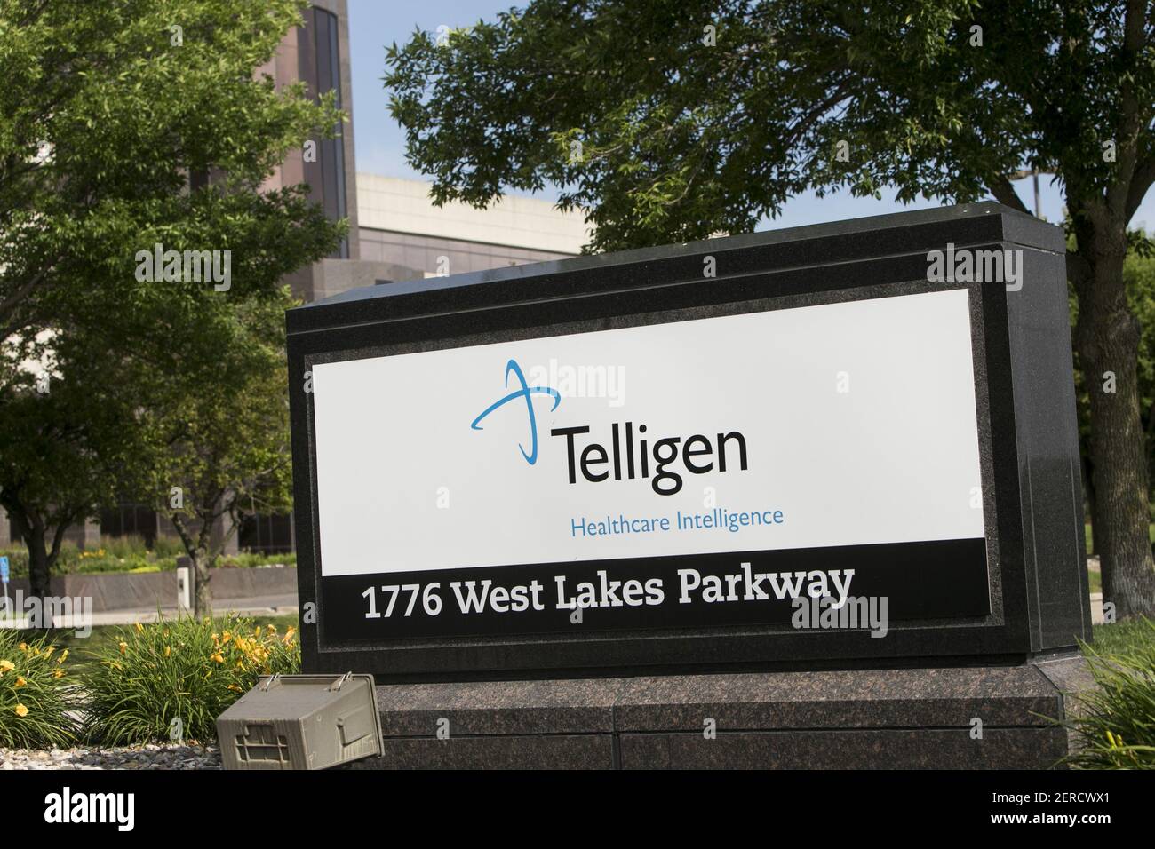 A logo sign outside of the headquarters of Telligen, Inc., in West Des ...