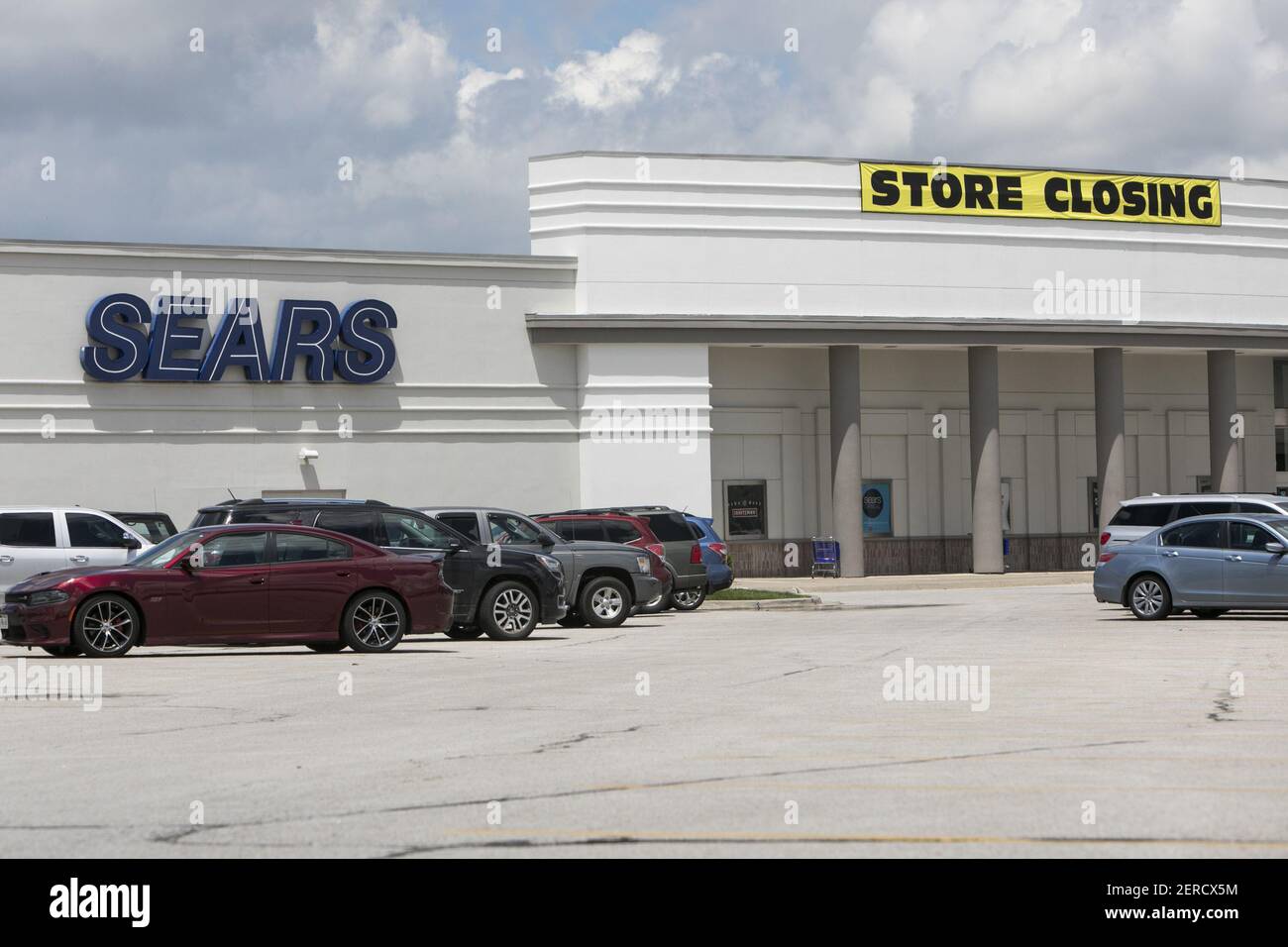 A logo sign and 'Store Closing' banner outside of a Sears retail store ...