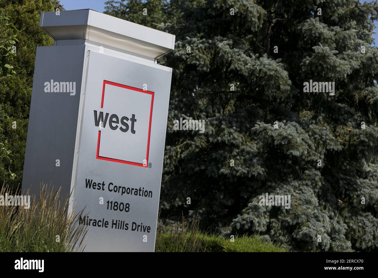 A logo sign outside of the headquarters of the West Corporation in ...