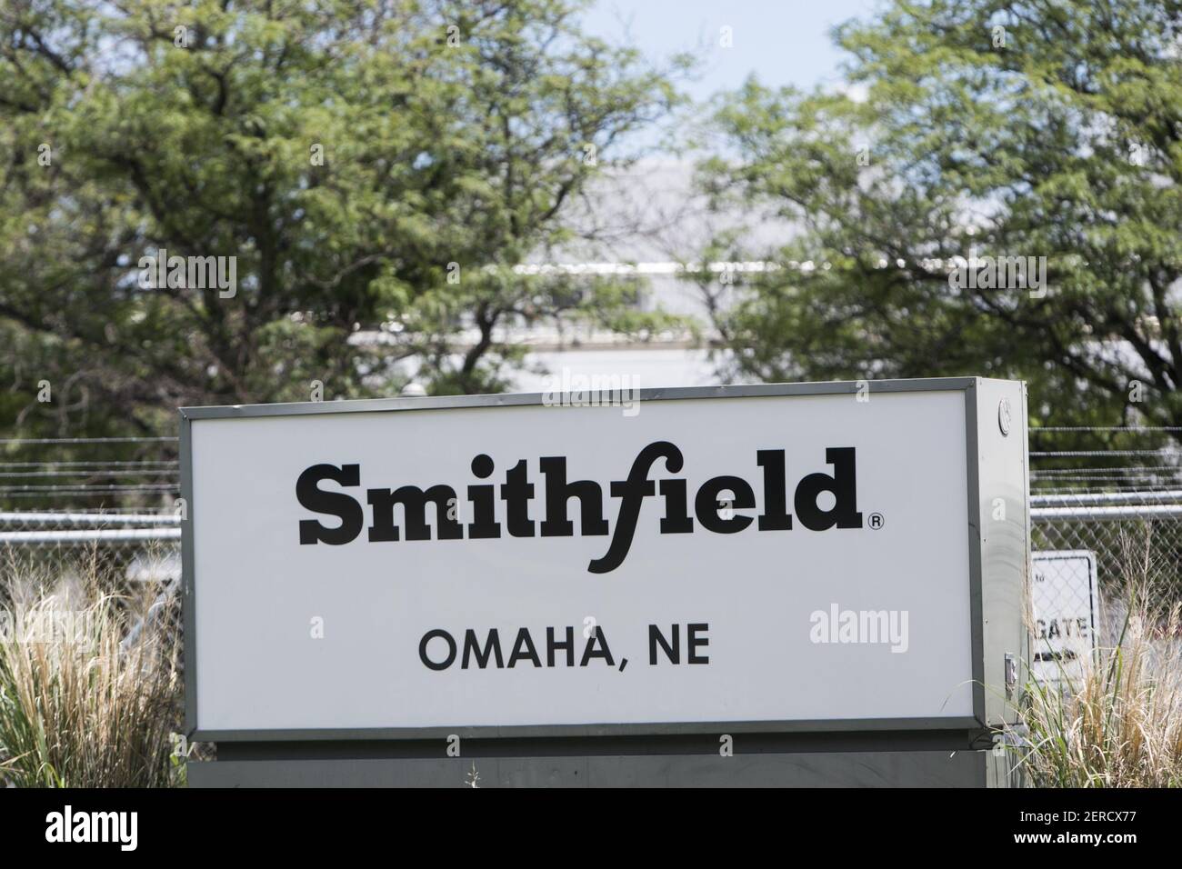 A logo sign outside of a facility occupied by Smithfield Foods, Inc ...