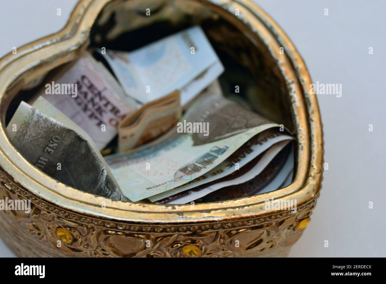 a donation box with a heart shape, collecting money for charity ...