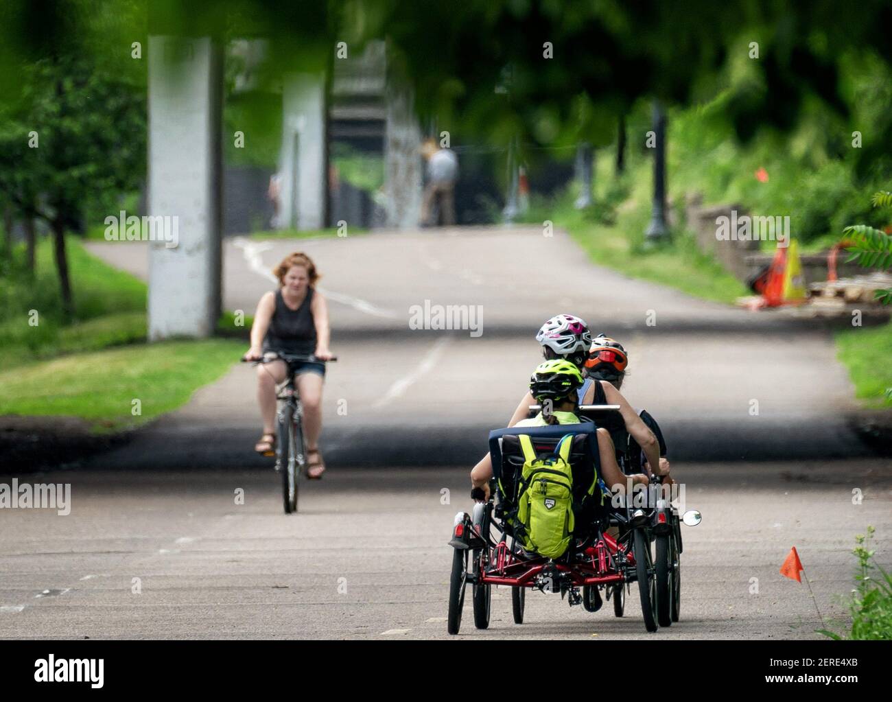 Volunteer Dale Hammerschmidt leads the triple seater down the Greenway ...