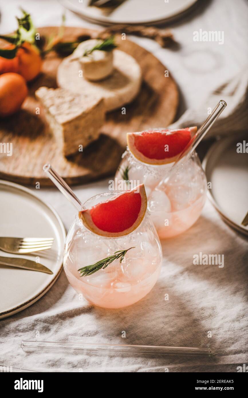 Home cocktail party table setting. Grapefruit rosemary margaritas in ...