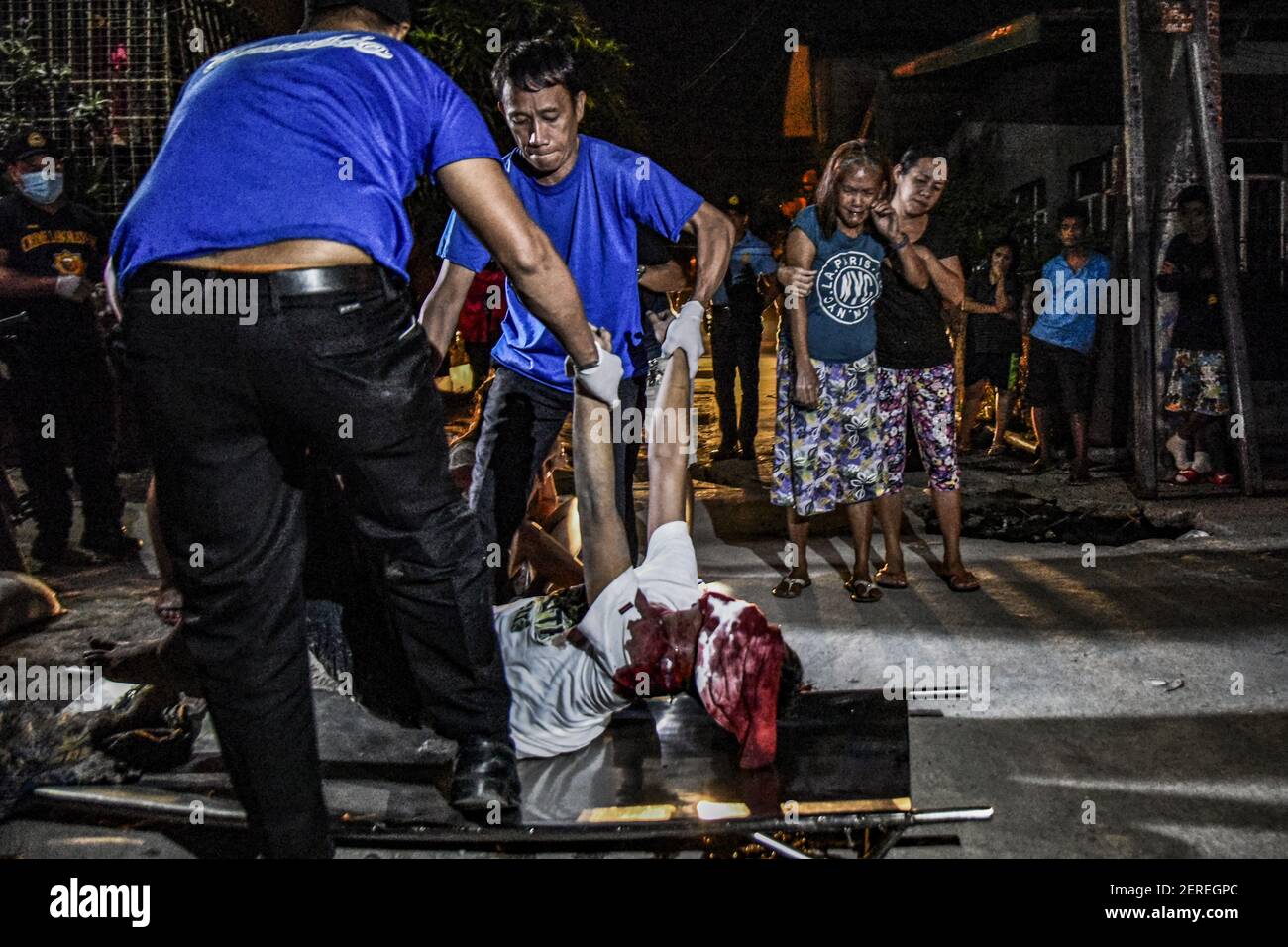 Relatives weep as the body of Jonathan Sevilla, who was shot dead by unknown attackers, is ...