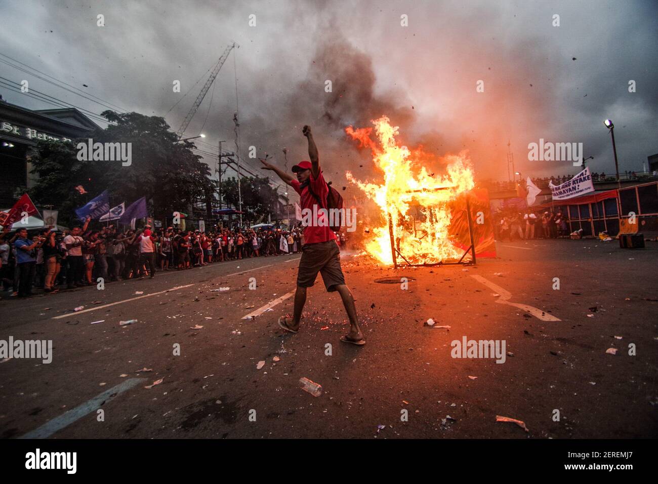 Protesters burn an effigy of President Duterte along Commonwealth Ave ...