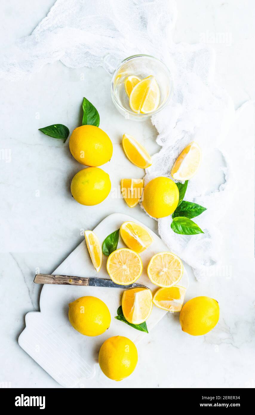 Whole and sliced lemon water flatlay Stock Photo - Alamy