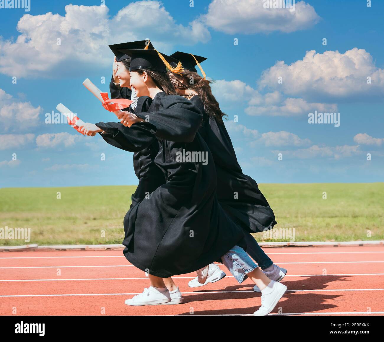 Group of Students Celebrating Graduation and running on the track Stock ...