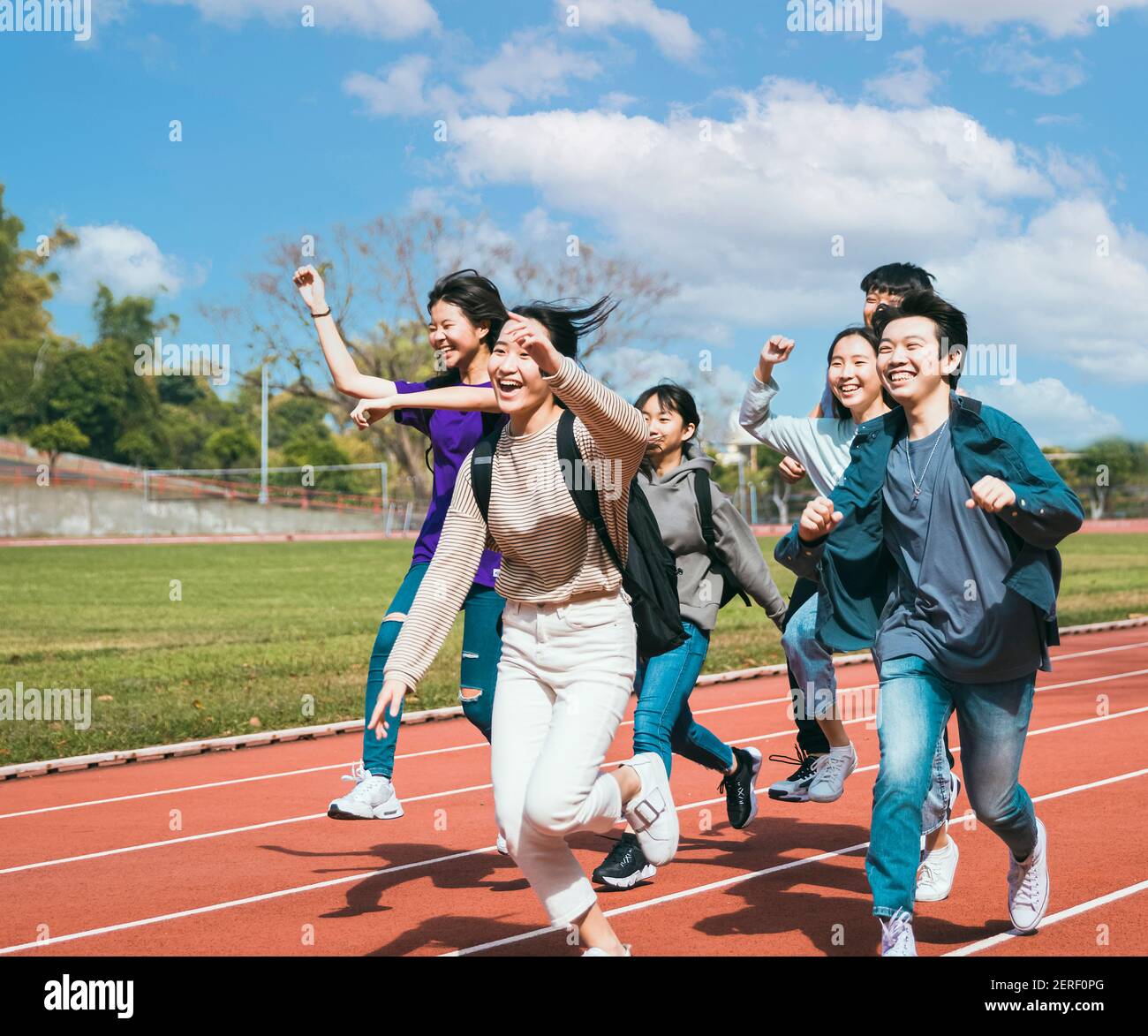 Happy young group student running in the campus Stock Photo - Alamy