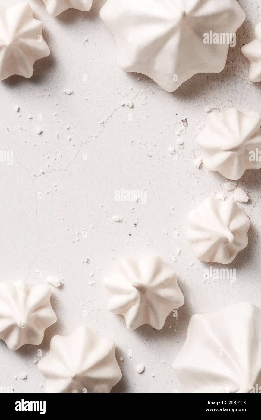 Meringues of different shapes, placed on a white background with ...