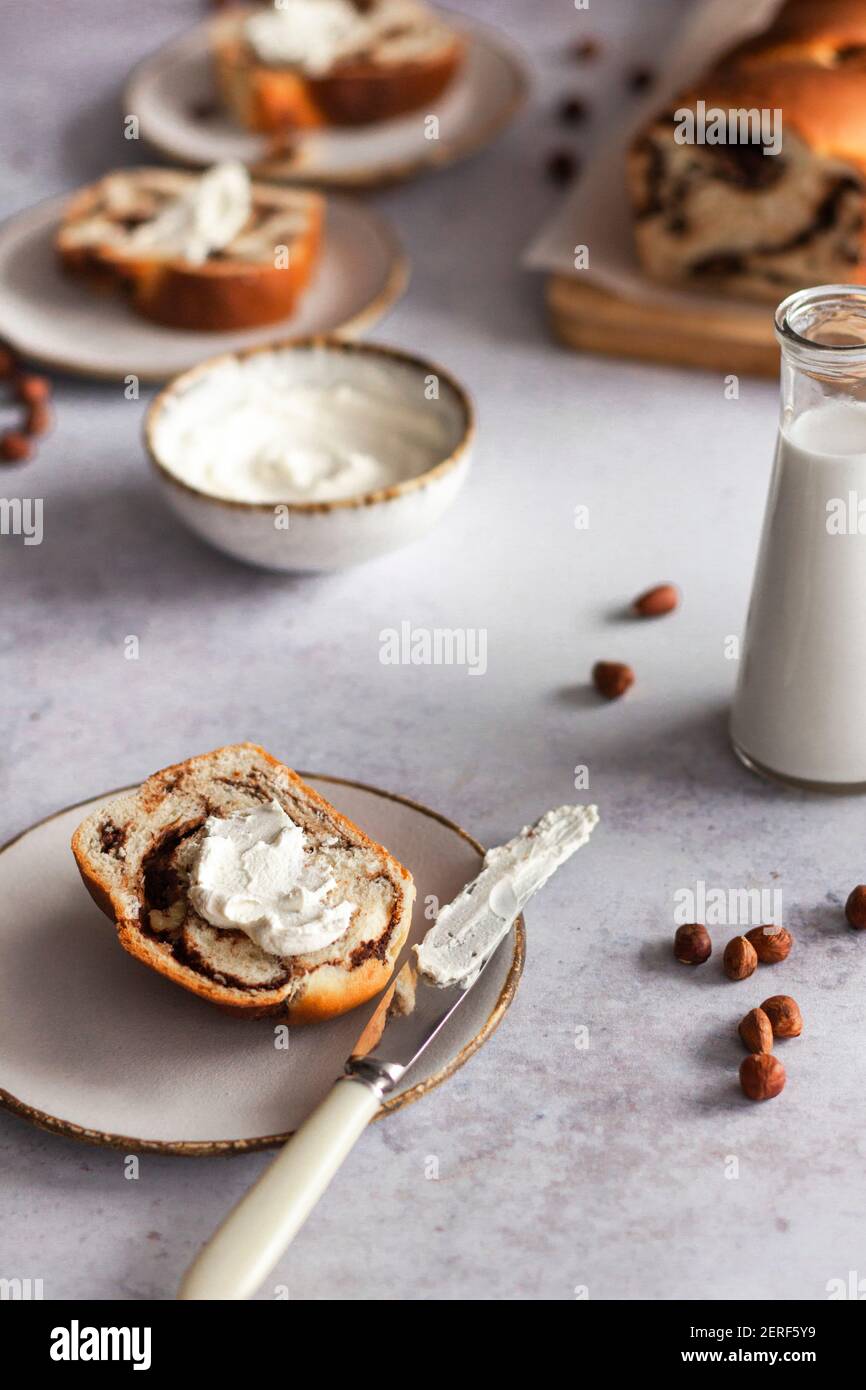 Chocolate and hazelnut babka served with cream cheese Stock Photo - Alamy