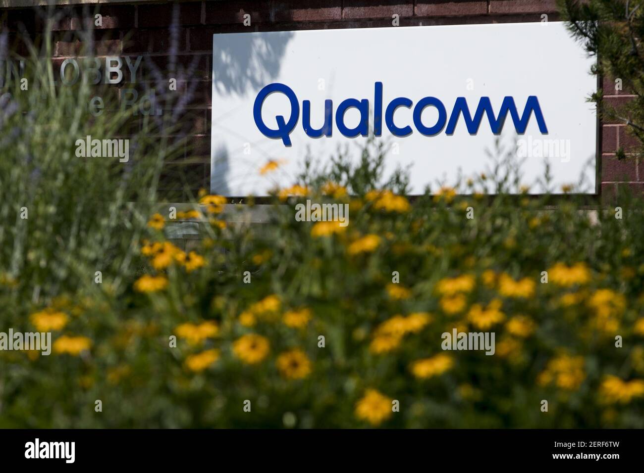 A logo sign outside of a facility occupied by Qualcomm in Boulder ...