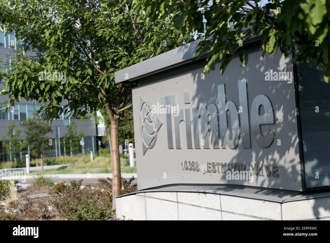 A logo sign outside of a facility occupied by Trimble, Inc., in ...