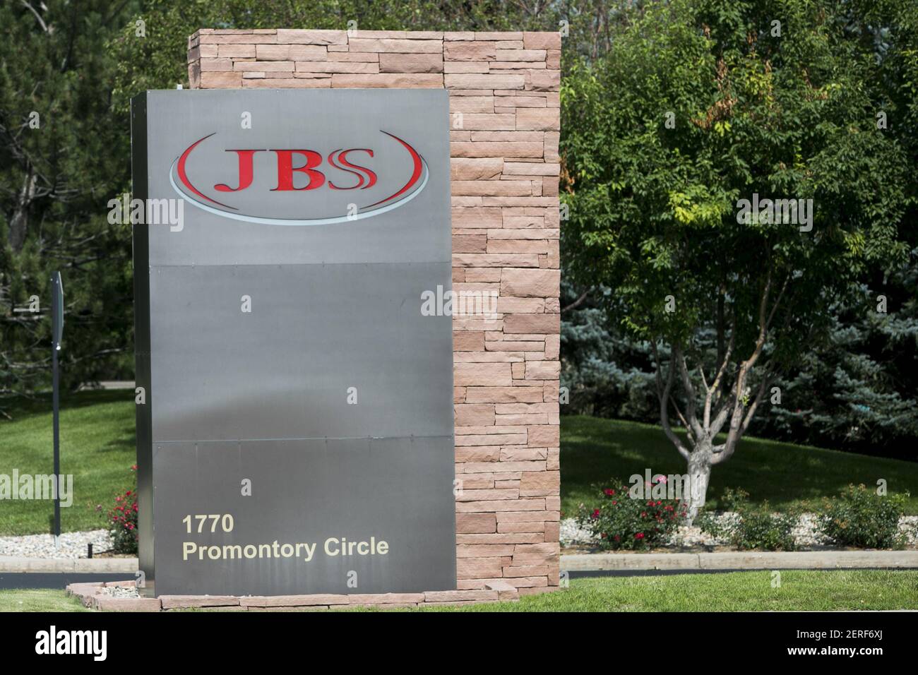 A logo sign outside of the headquarters of JBS USA Holdings, Inc., in ...