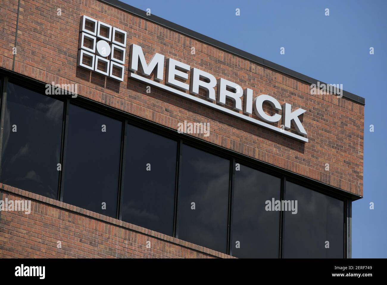 A logo sign outside of a facility occupied by Merrick & Company in ...
