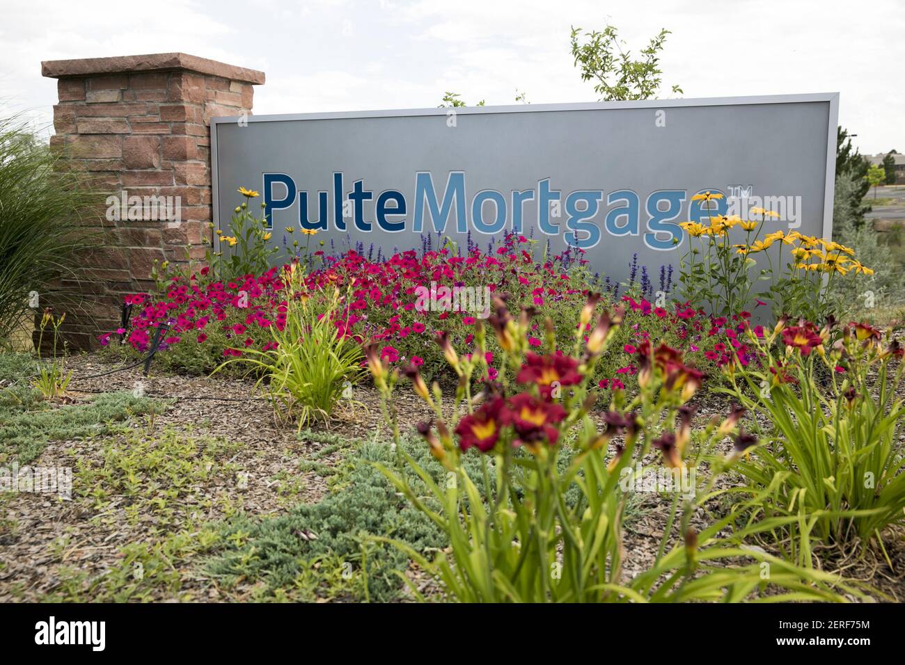A logo sign outside of a facility occupied by Pulte Mortgage, a ...