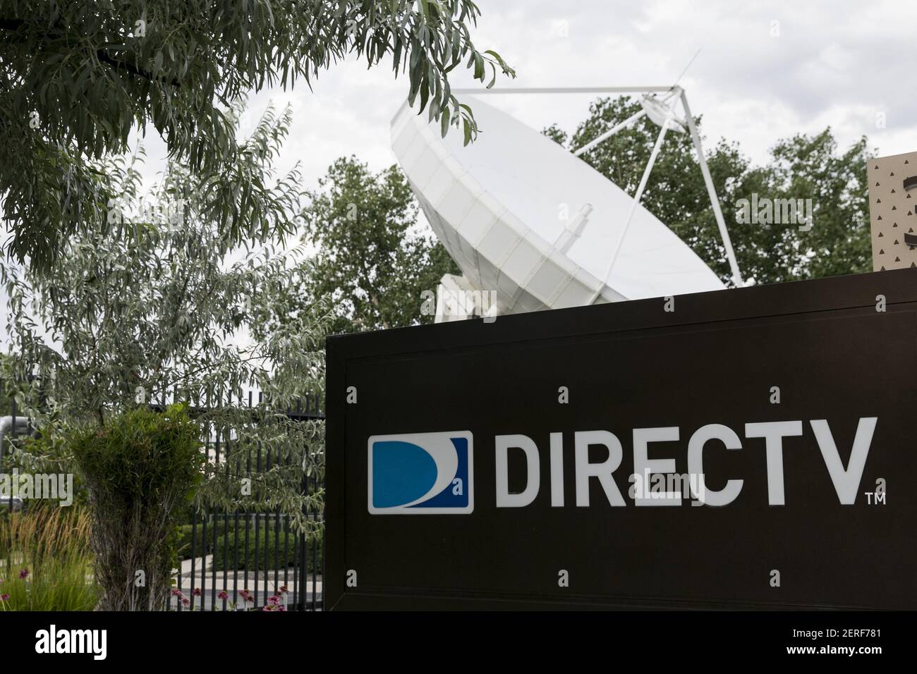 A logo sign outside of a facility occupied by DirecTV in Englewood ...