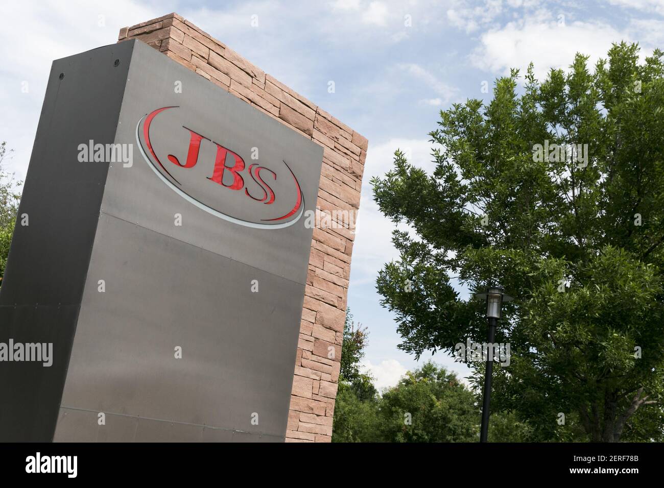 A logo sign outside of the headquarters of JBS USA Holdings, Inc., in ...