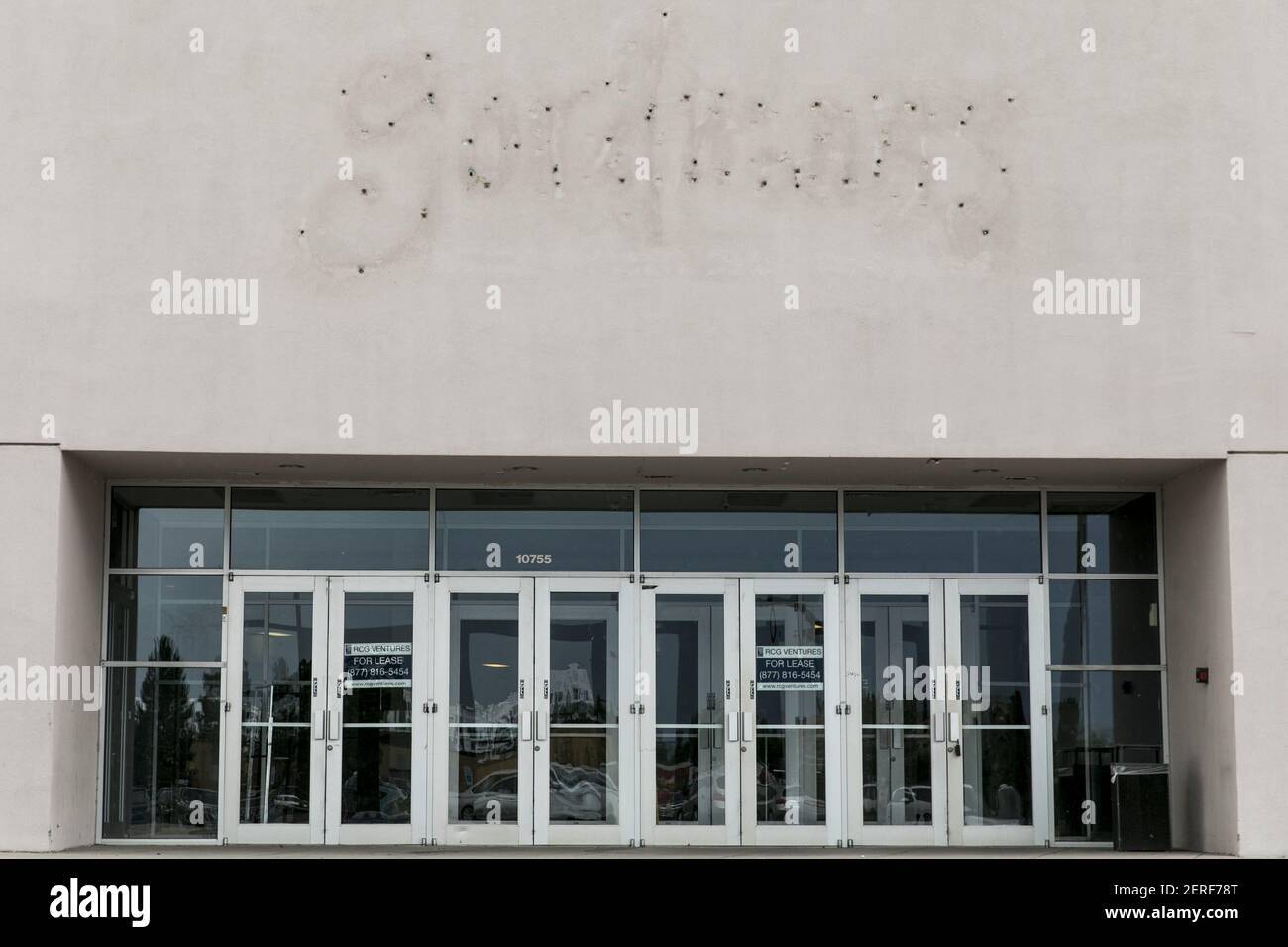The faded outline of a logo sign outside of a closed Gordmans retail ...