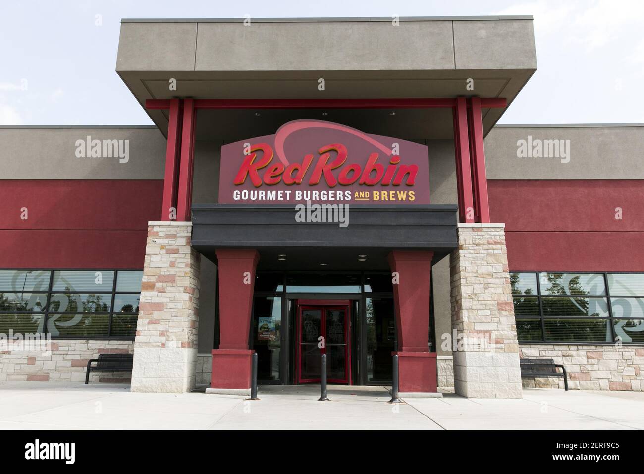 A logo sign outside of a Red Robin Gourmet Burgers and Brews restaurant ...