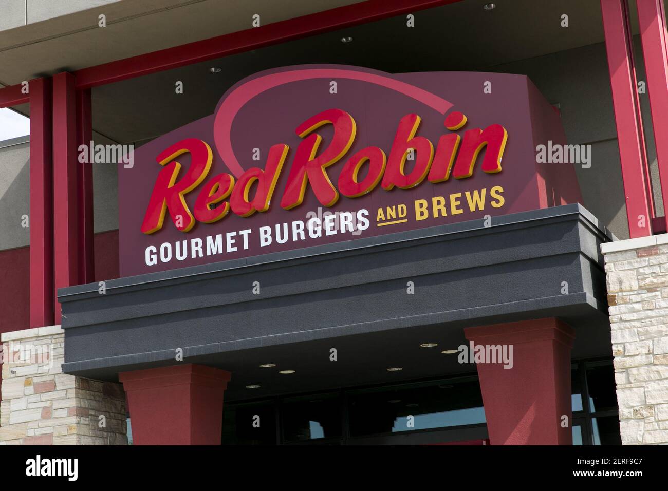 A logo sign outside of a Red Robin Gourmet Burgers and Brews restaurant ...