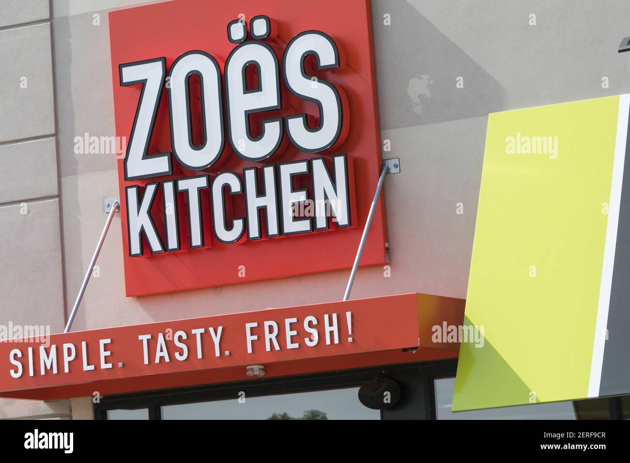A logo sign outside of a Zoës Kitchen fast casual restaurant in ...