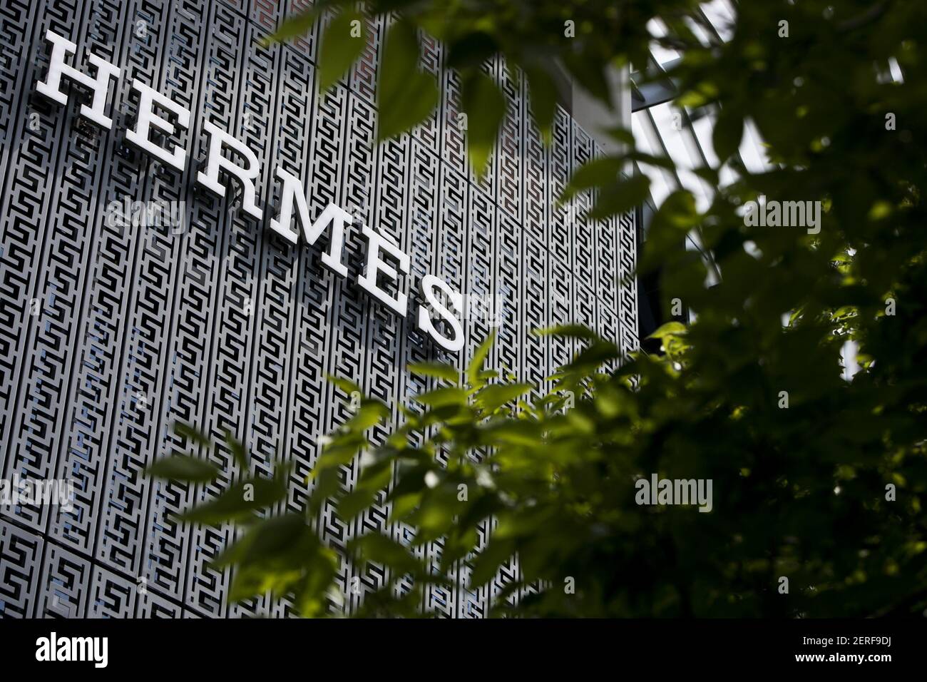 A logo sign outside of a Hermes retail store location in Denver ...