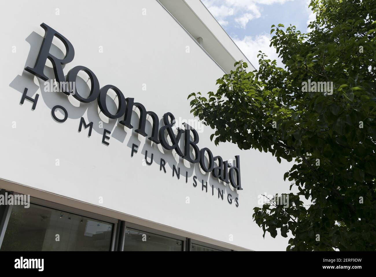 A logo sign outside of a Room & Board retail store location in Denver ...