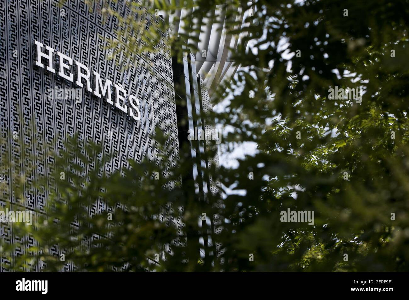 A logo sign outside of a Hermes retail store location in Denver ...