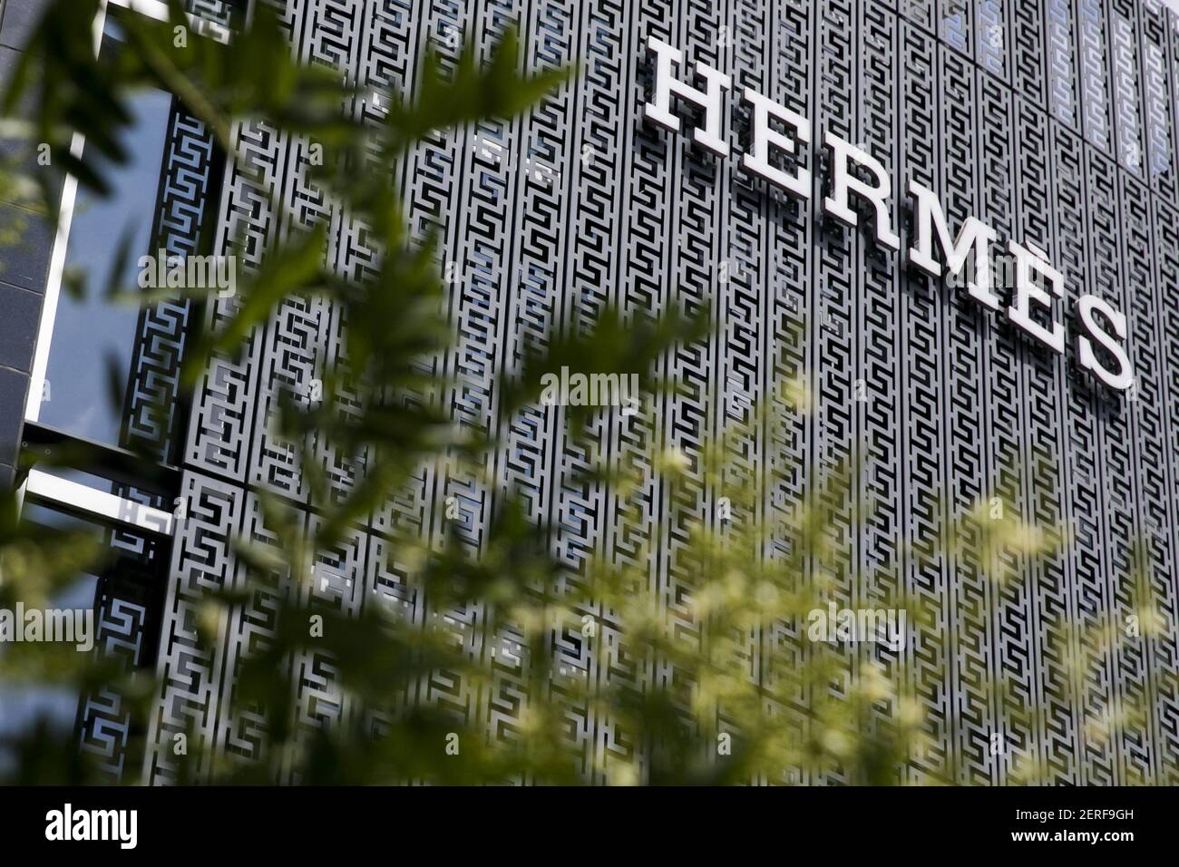 A logo sign outside of a Hermes retail store location in Denver ...
