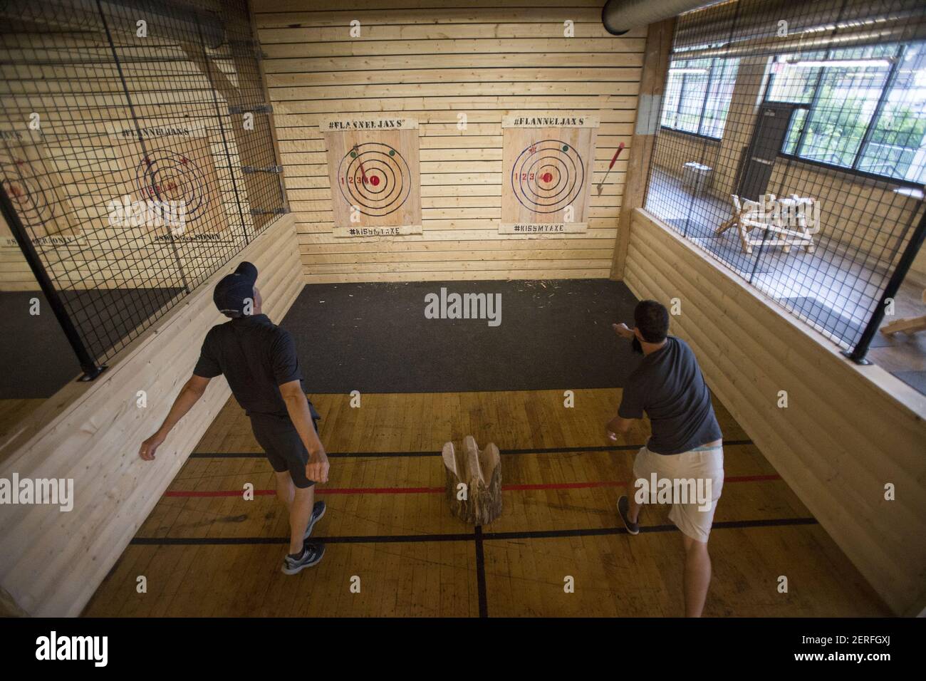 Mike Dufresne, left, and Jason Kimmel go toe-to-toe in an axe throwing ...