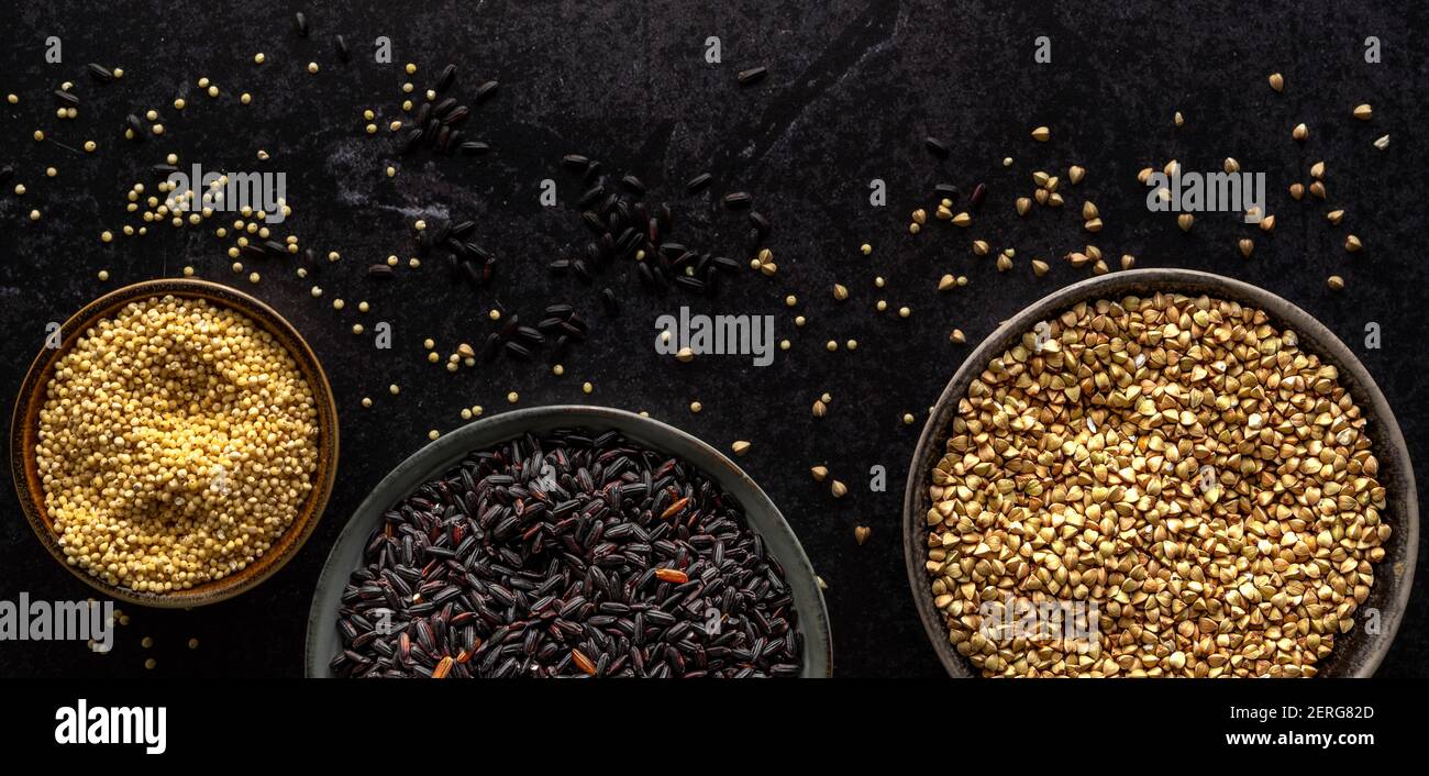 Three small bowls with black rice, millet and buckwheat seeds Stock ...