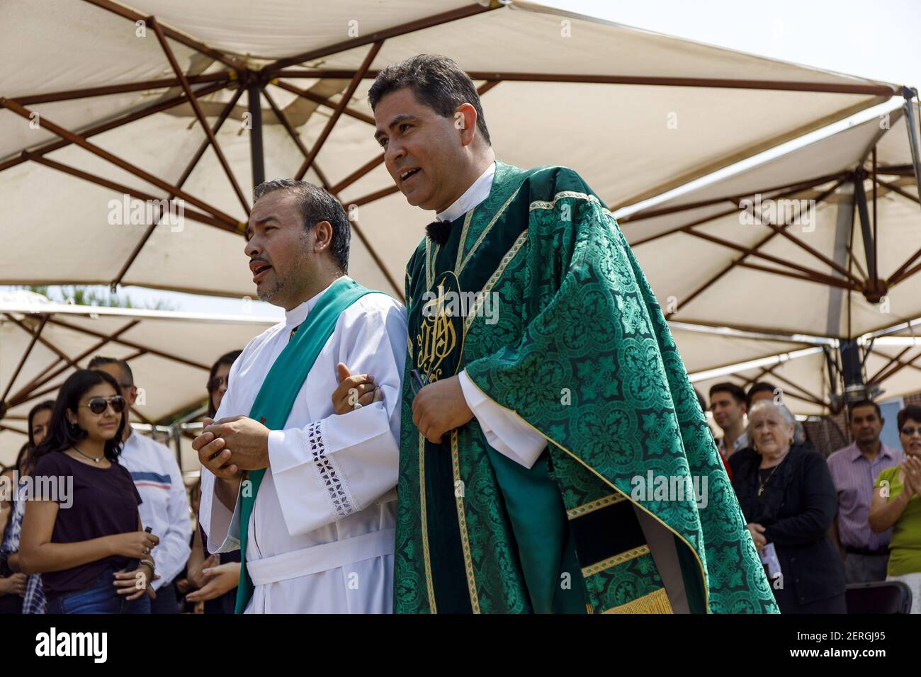 The Rev. Esequiel Sanchez (right) begins a Mass of thanksgiving Sunday ...