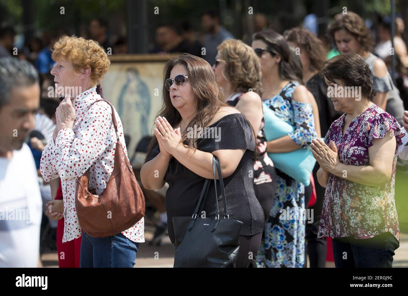 People attend as the Rev. Esequiel Sanchez celebrates a Mass of ...