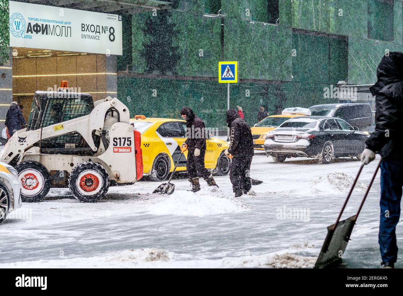Moscow. Russia. February 12, 2021. Several utility workers with shovels ...