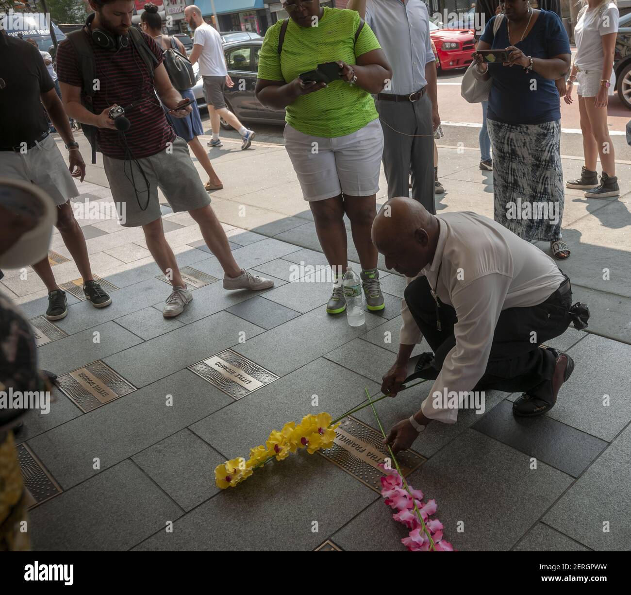 Ernie Spencer puts out flowers on the walk of fame as a memorial to ...