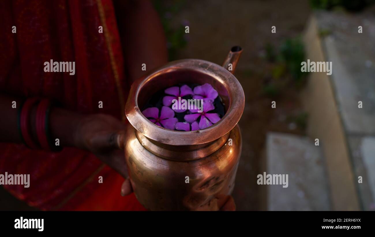 Closeup shot of Copper kalash filled with sacred water to offer God ...