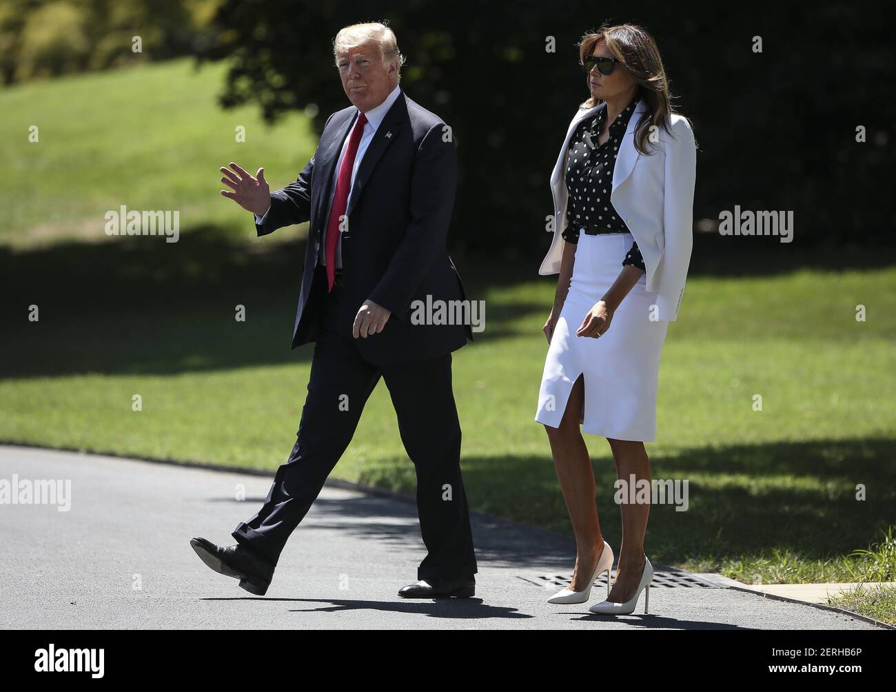 President Donald Trump and first lady Melania Trump walk across the ...