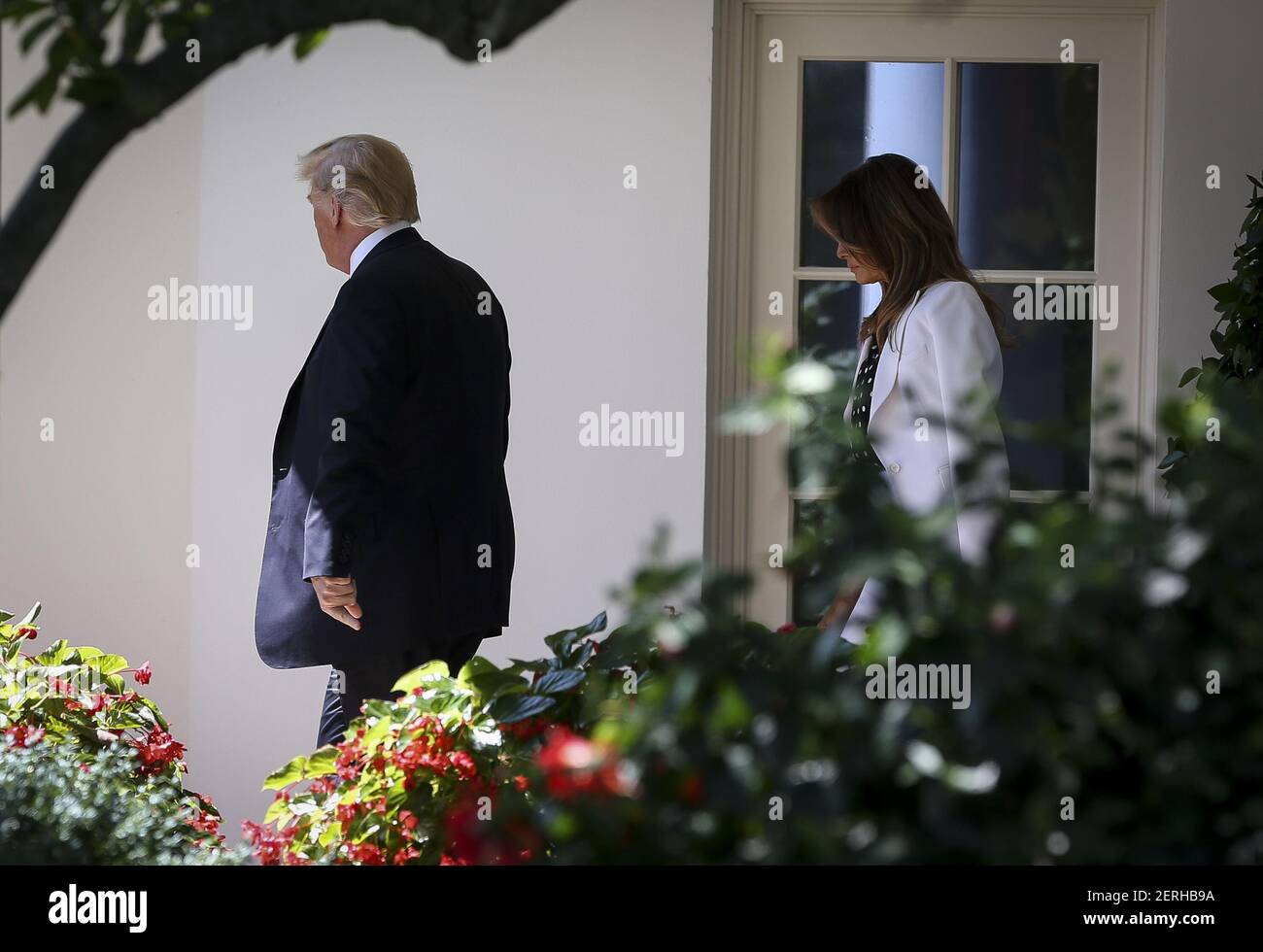 President Donald Trump and first lady Melania Trump walk out of the ...