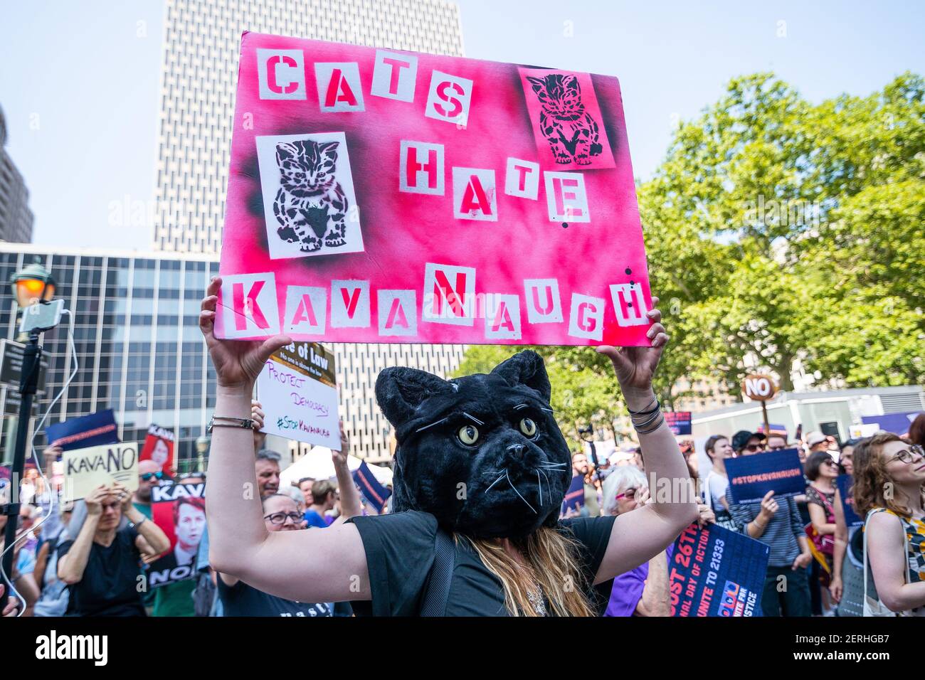 Demonstrators hold signs while participating in a national day of ...