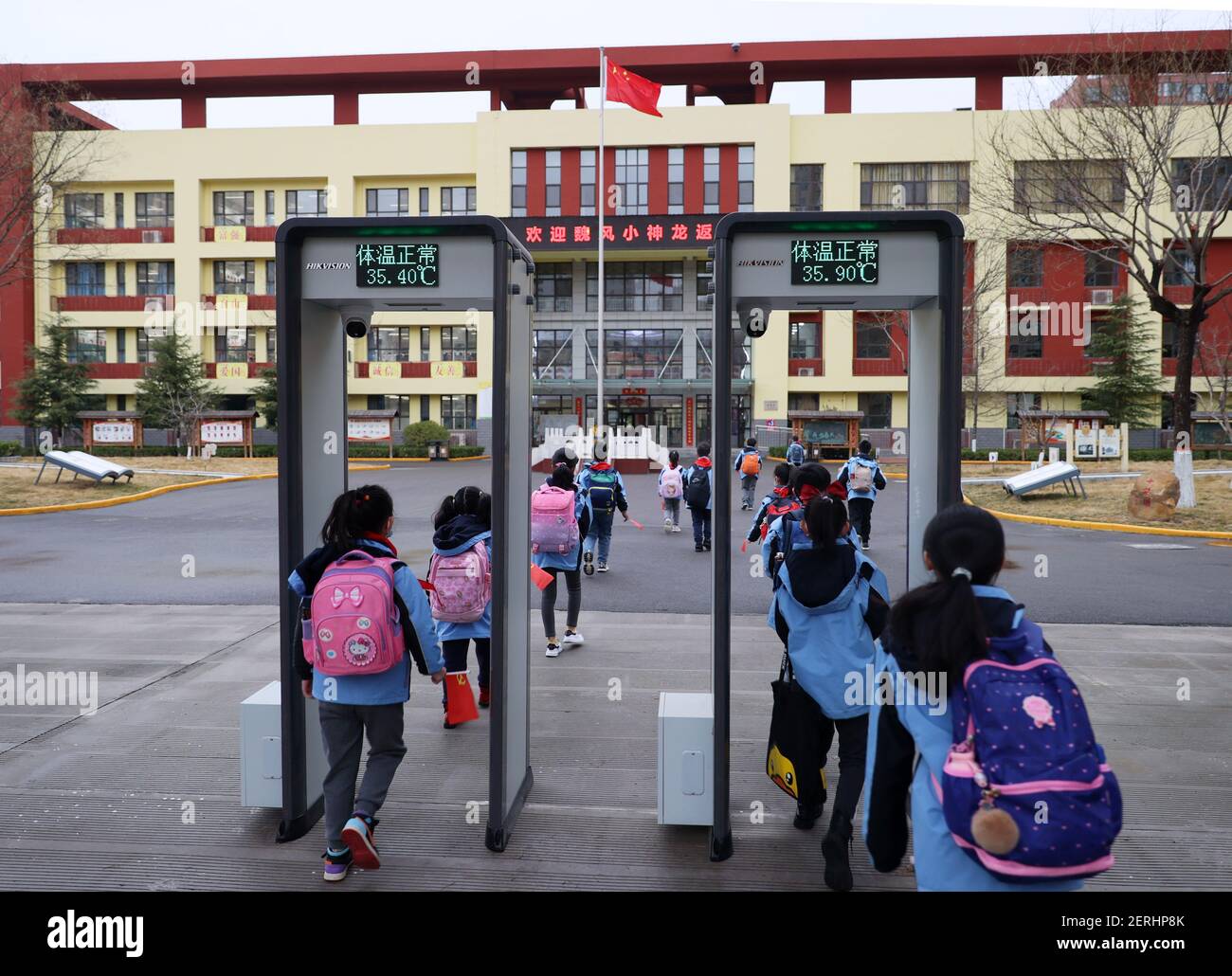 YUNCHENG, CHINA - MARCH 1, 2021 - Pupil students pass through a ...