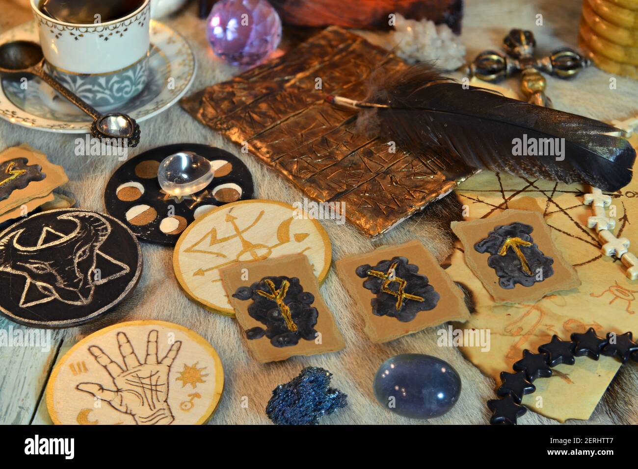 Runes, sacred symbols, crystals and magic ritual objects on witch table ...