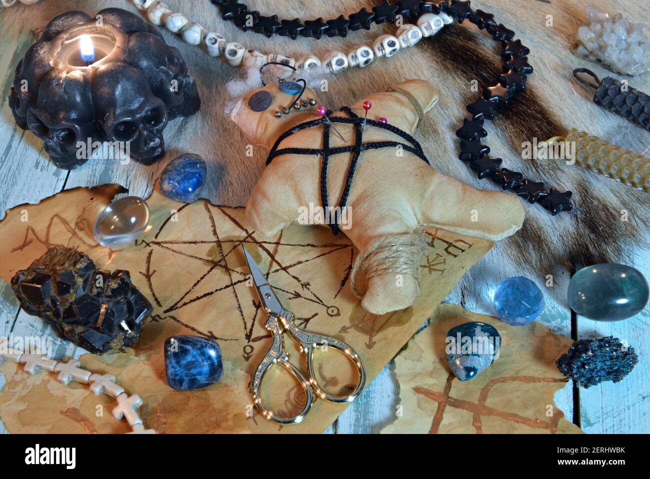 Voodoo ritual with craft scary doll, pentargam on paper, black candle ...