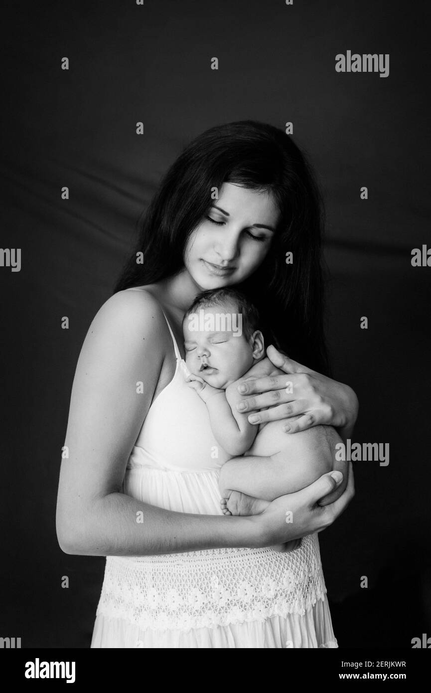 3 Mother Holding Her Newborn Daughter In Her Arms At A Newborn