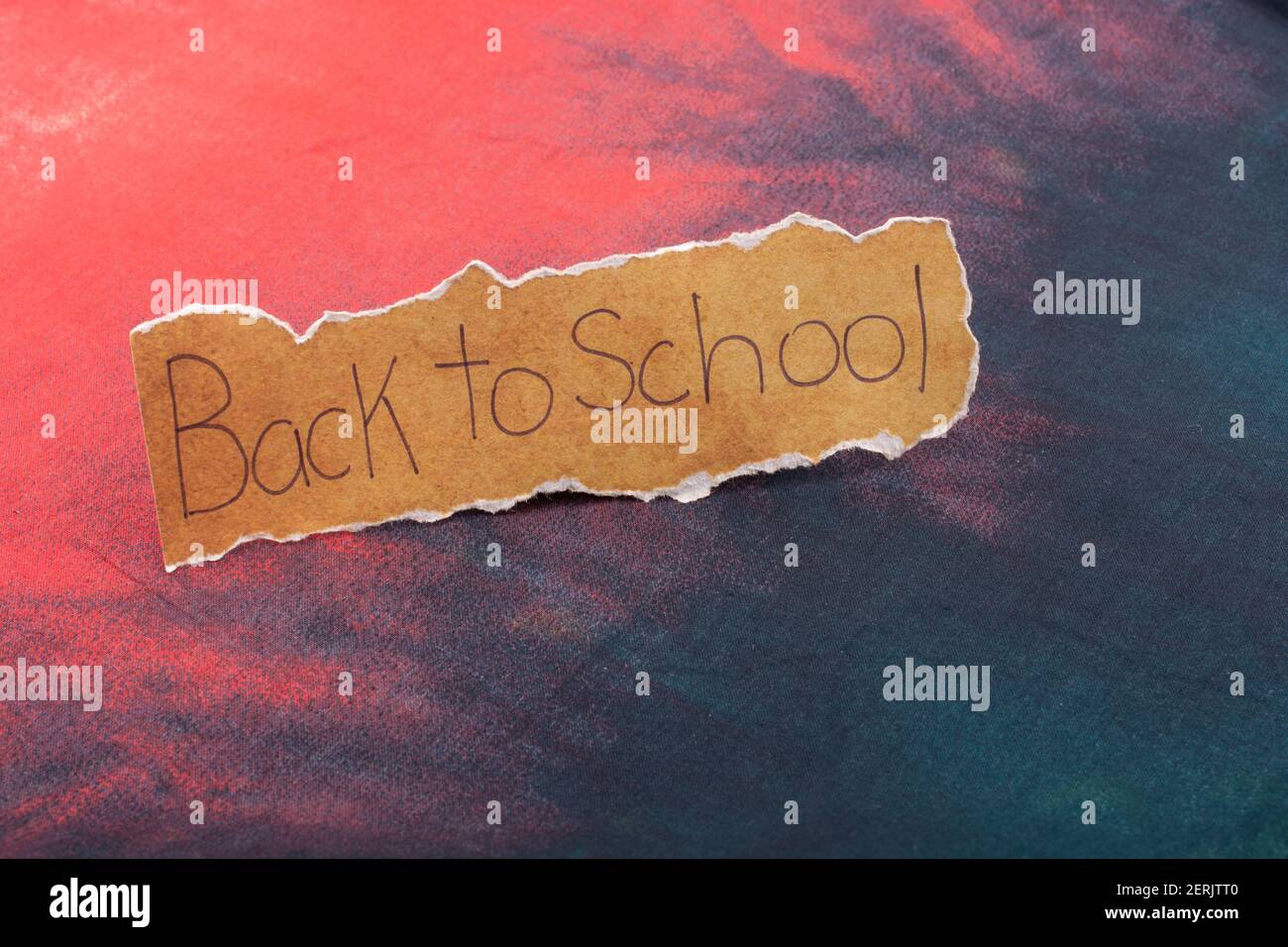 Back to school wording on a piece of torn paper Stock Photo - Alamy