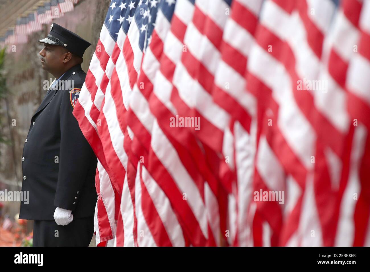 An FDNY Firefighter stands guard alongside the FDNY 343 Memorial Wall ...