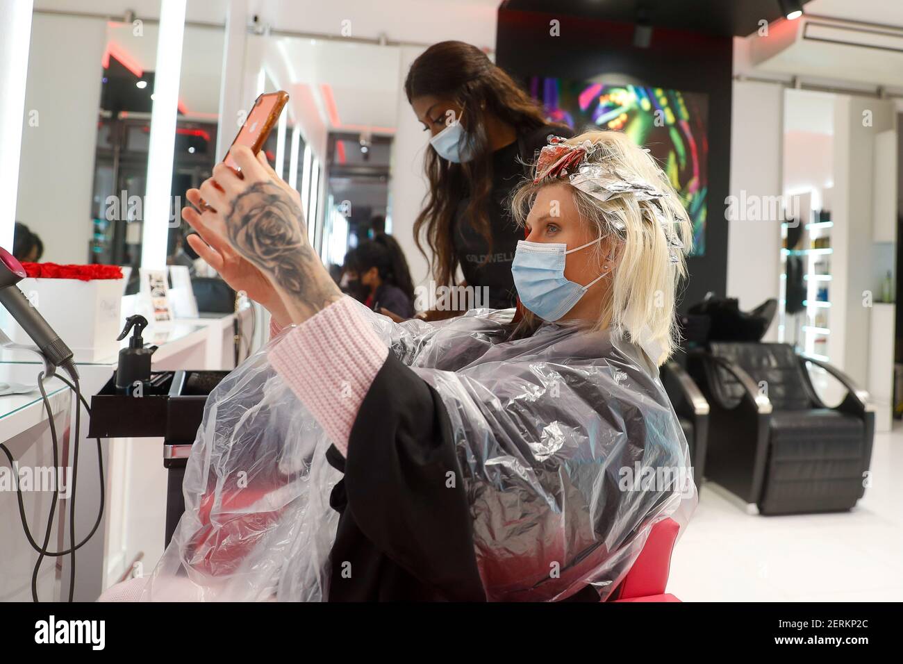 Berlin Germany. 01st Mar 2021. As the first customer of the hairdresser s shop Magali Coiffeur Arielle Rippegather gets her hair cut and coloured after the reopening. After weeks of forced break due