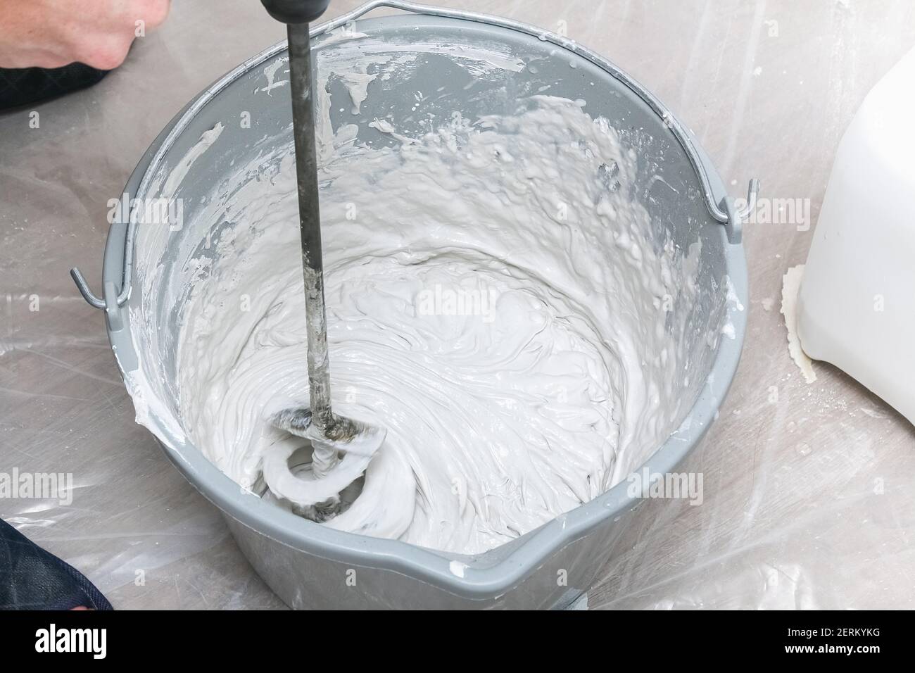 A male worker spreads the putty mixture and flattens the wall Stock ...