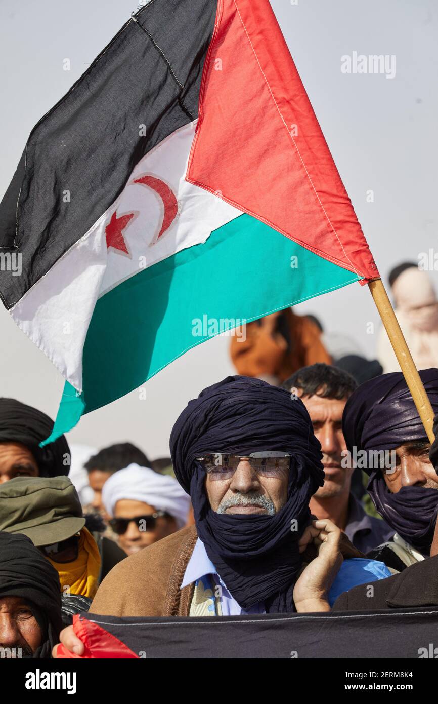 Sahrawis watch soldiers march in a parade during the celebrations ...